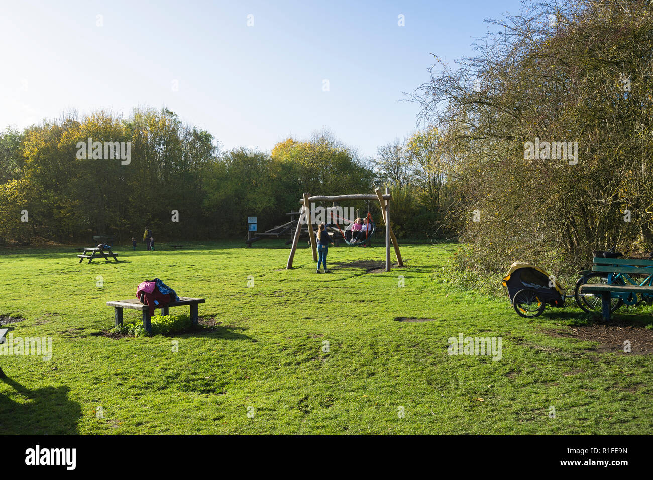 Children playing on swing in adventure playground milton park hi-res ...