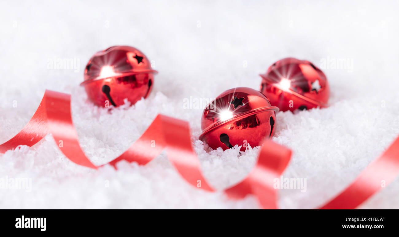 Christmas bells in the snow, festive background Stock Photo - Alamy