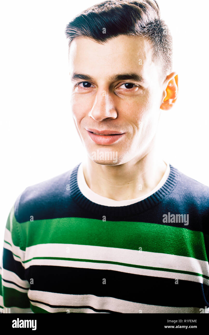 Portrait of a smart serious young man standing against white bac Stock ...