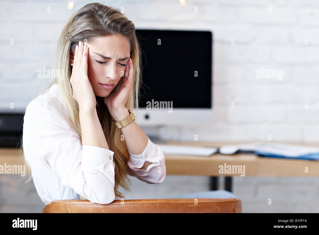 Portrait of beautiful millennial woman working in modern home office ...