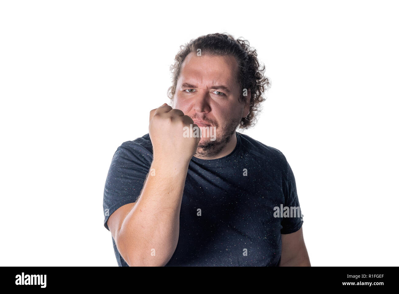 Serious man shows the gesture clenched fist, looking at the camera ...