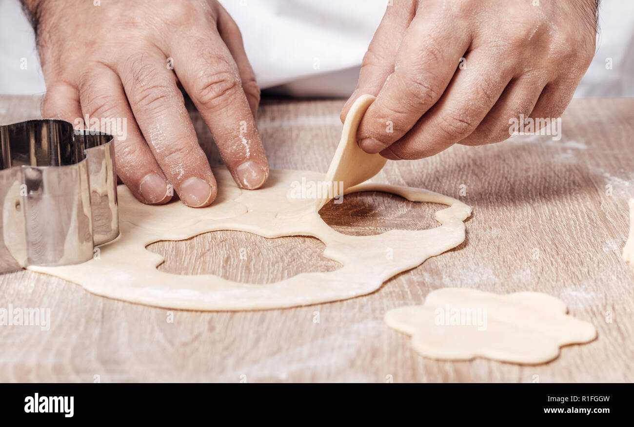 man using bakery mold for cookies, hands closeup Stock Photo - Alamy