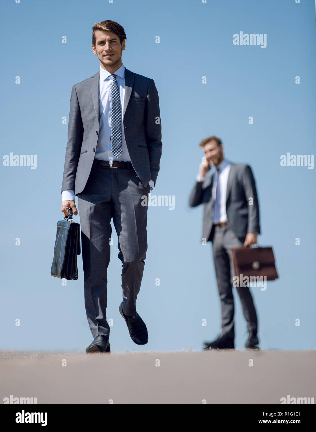 successful young businessman walking down the street Stock Photo - Alamy