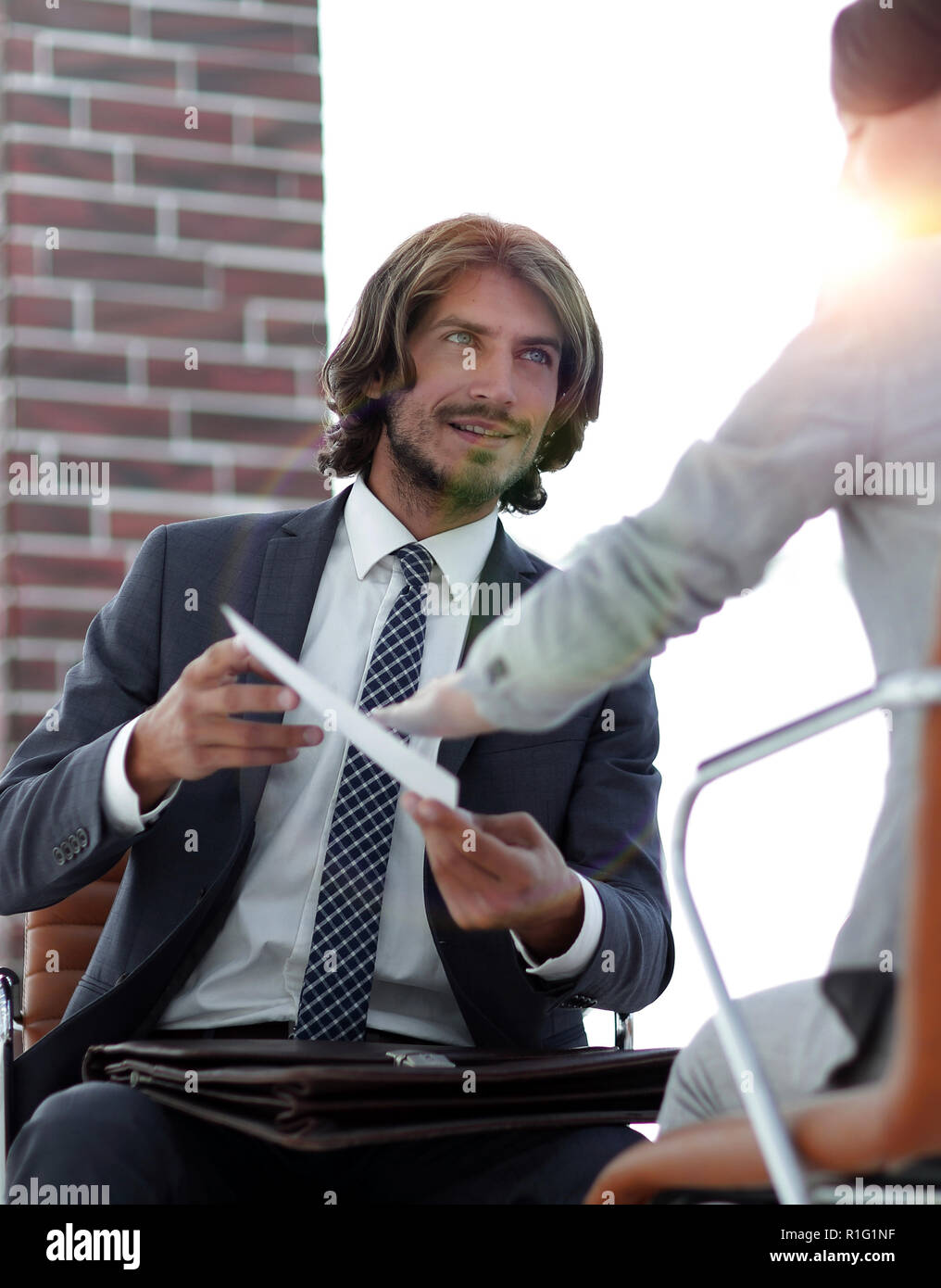 A relaxed conversation of a man and a woman in the office Stock Photo ...