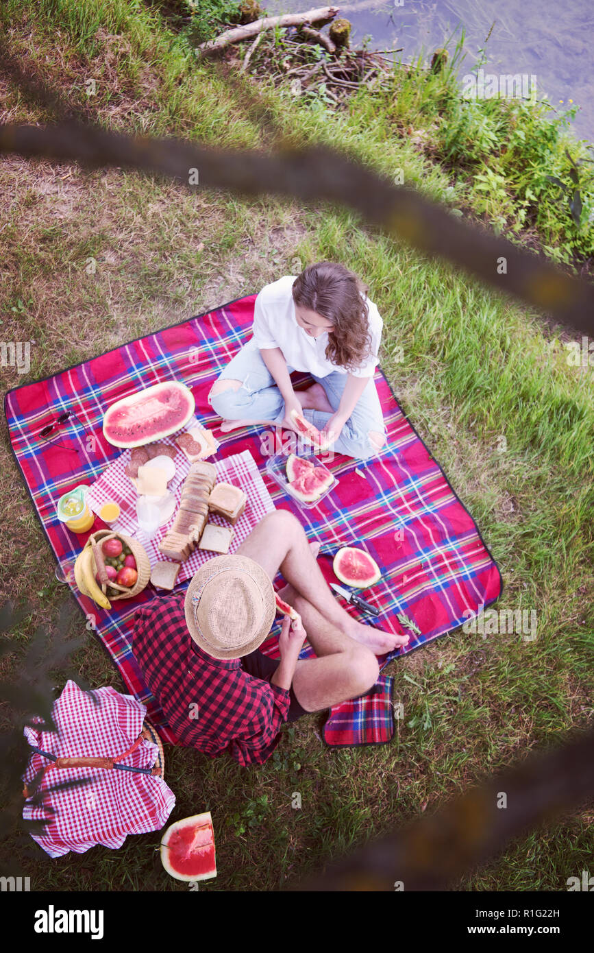 Couple in love enjoying picnic time drink and food in beautiful nature ...