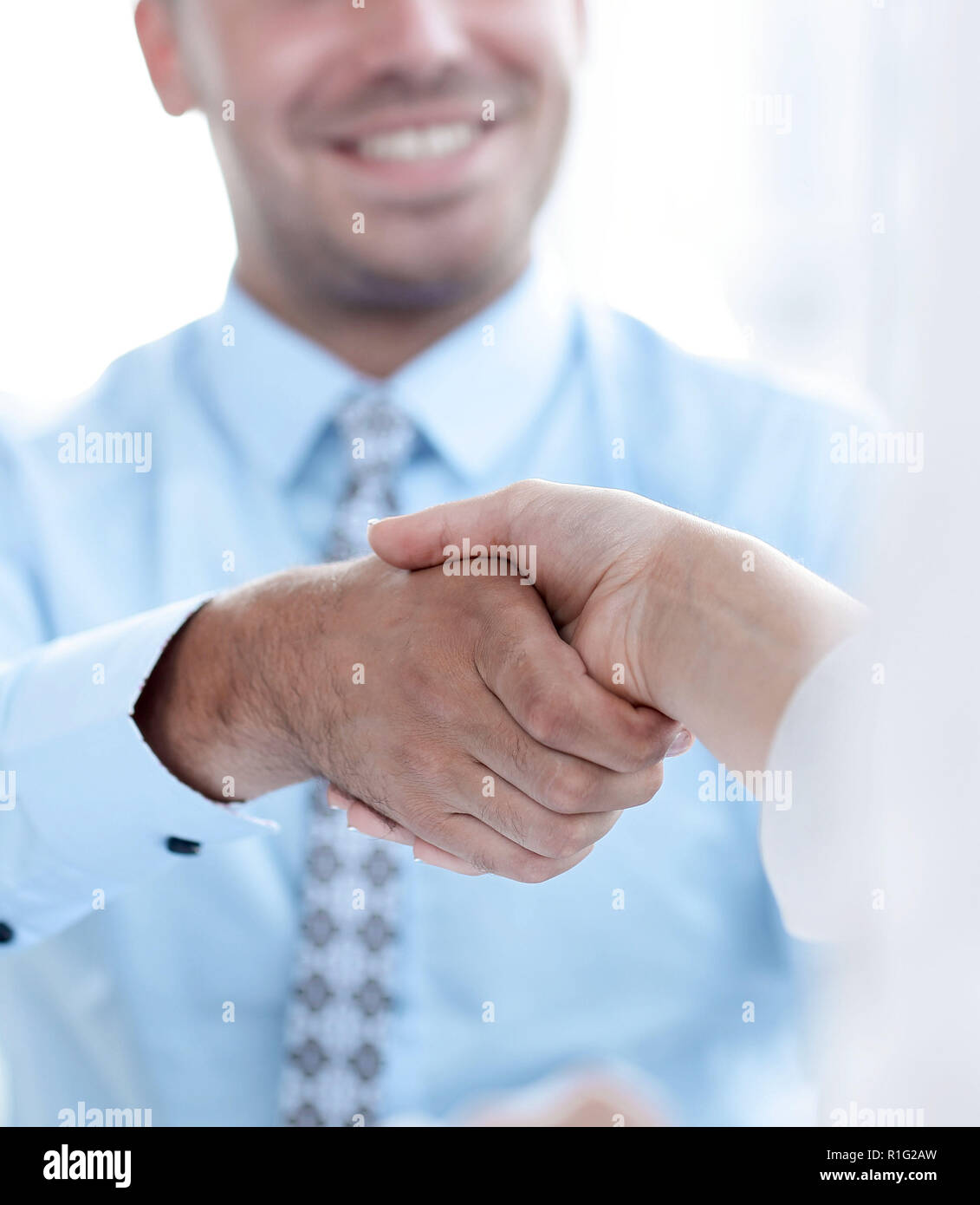 closeup. Manager shakes the hand of a woman client Stock Photo - Alamy