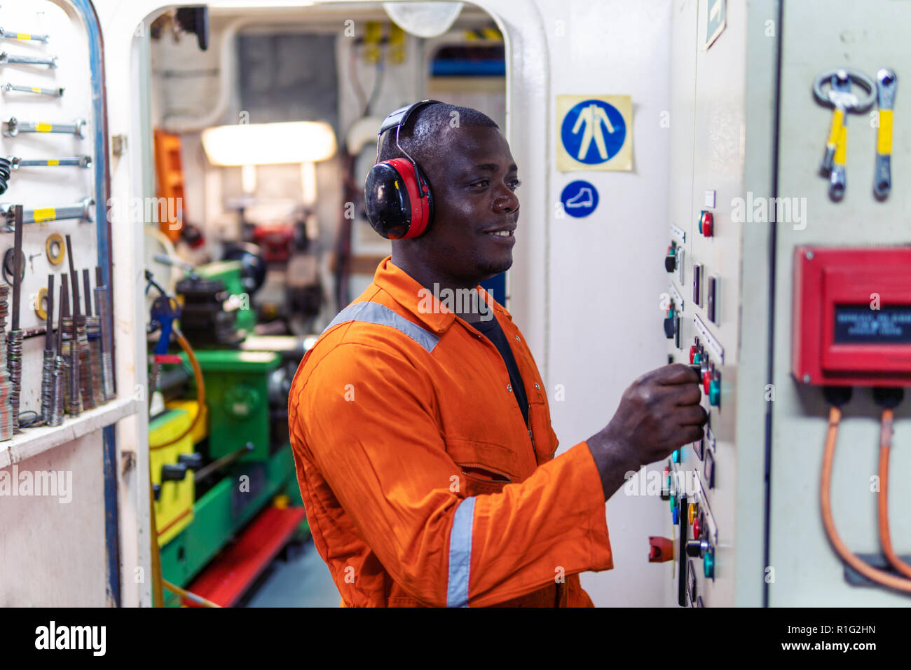 Marine engineer officer working in engine room Stock Photo - Alamy