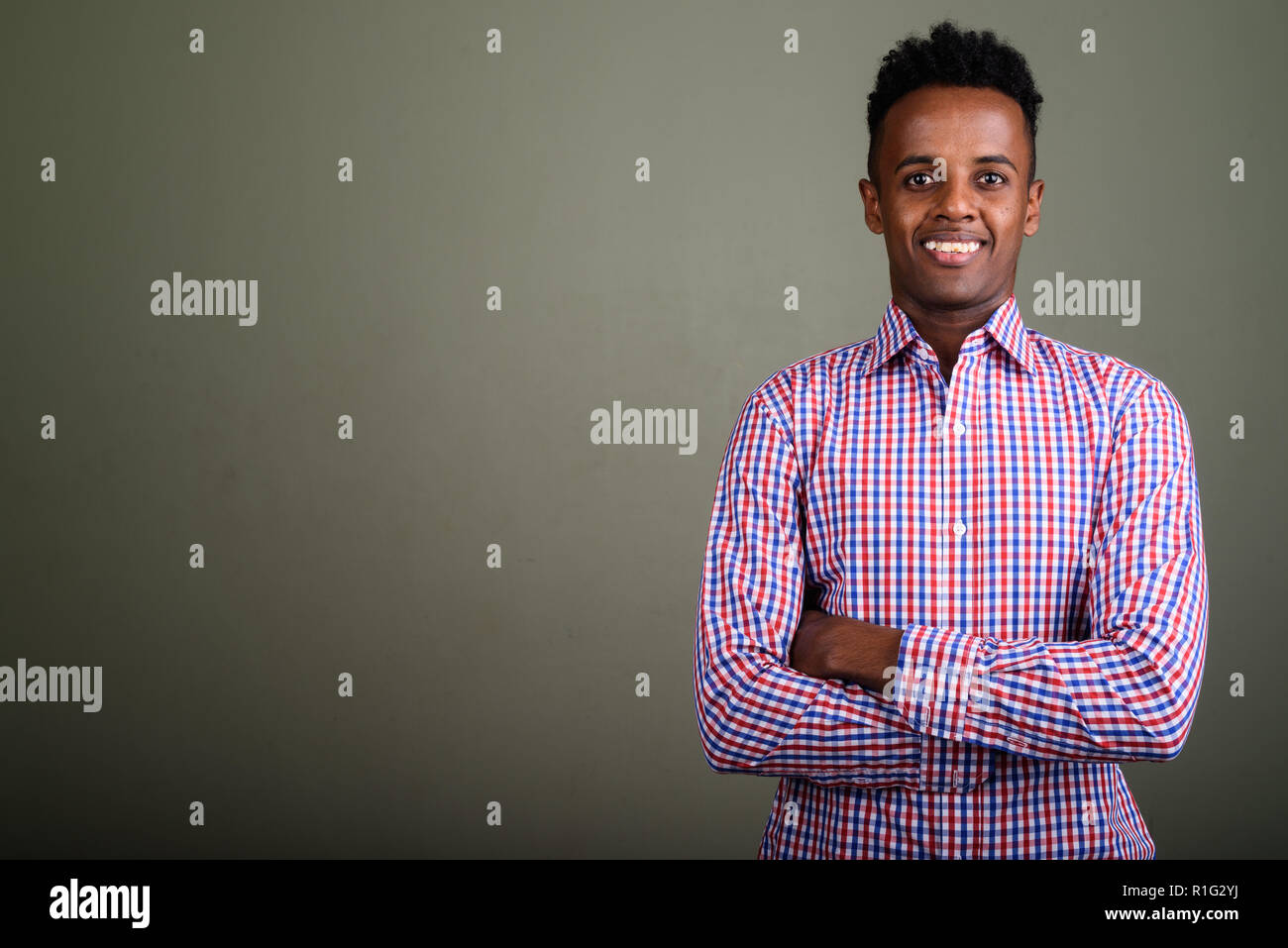 Young handsome African businessman against colored background Stock ...