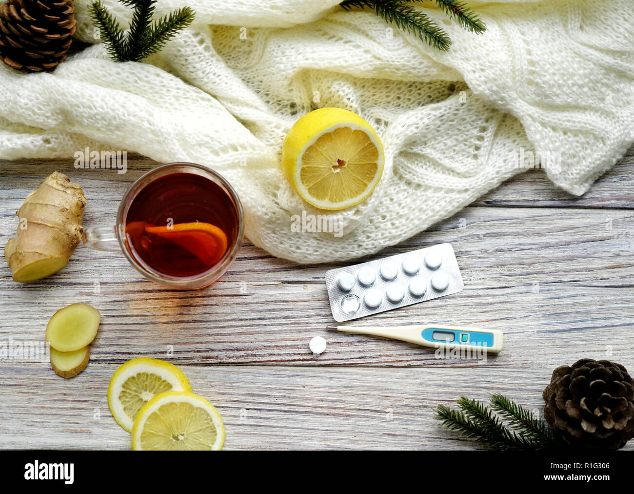 Top view Wooden word sick, Tea with lemon, thermometer, ginger, honey ...