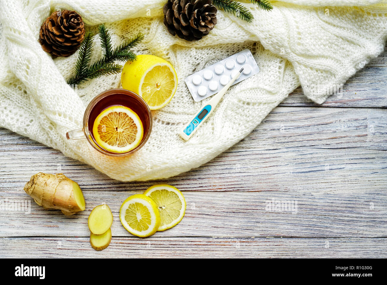 Top view Wooden word sick, Tea with lemon, thermometer, ginger, honey ...