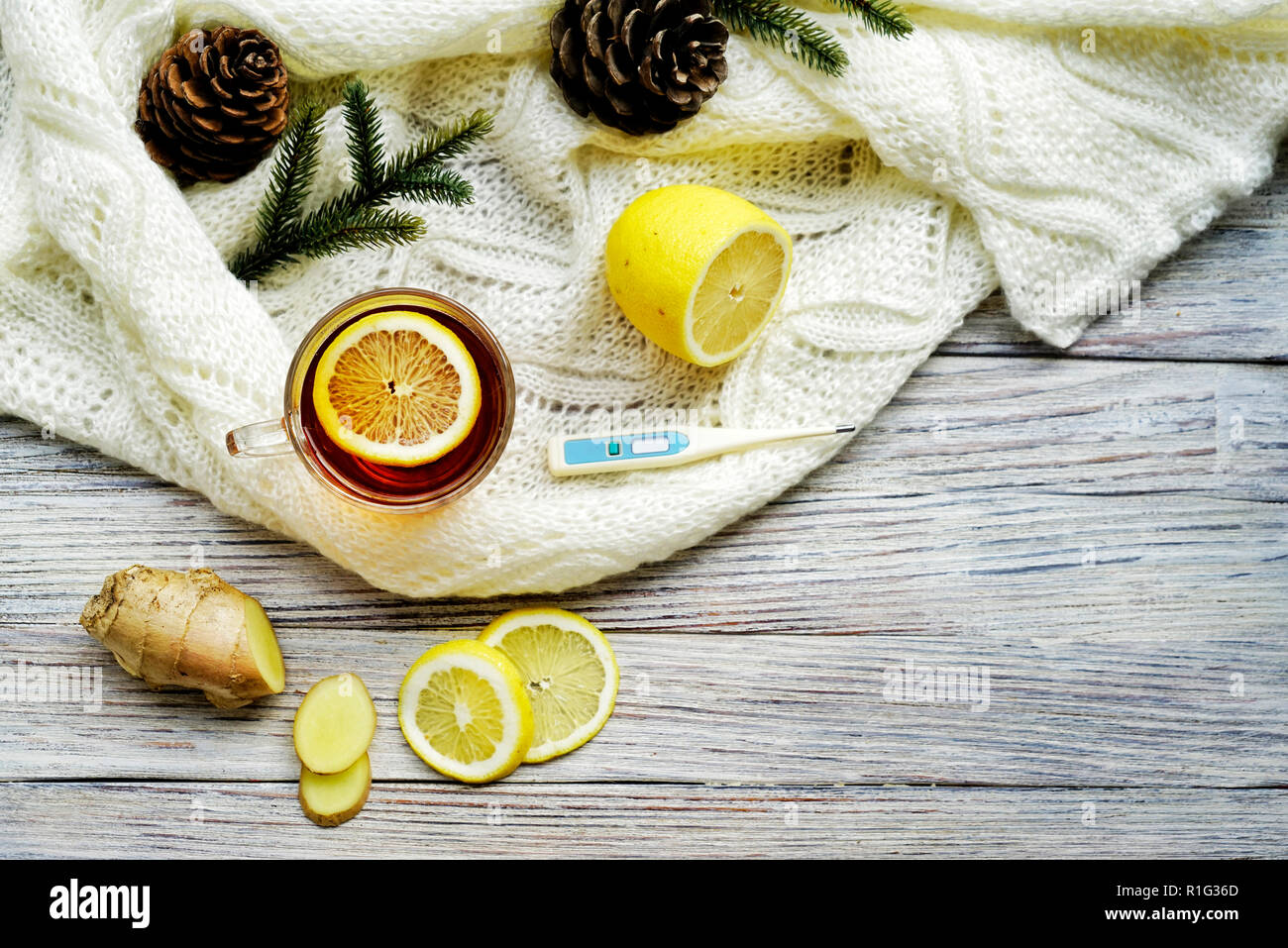 Top view Wooden word sick, Tea with lemon, thermometer, ginger, honey ...