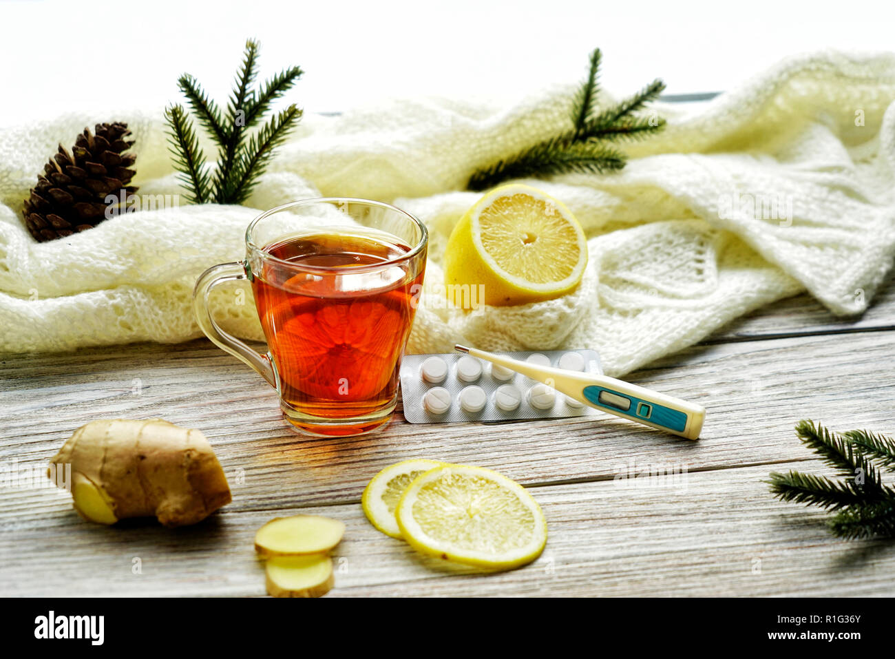 Top view Wooden word sick, Tea with lemon, thermometer, ginger, honey ...