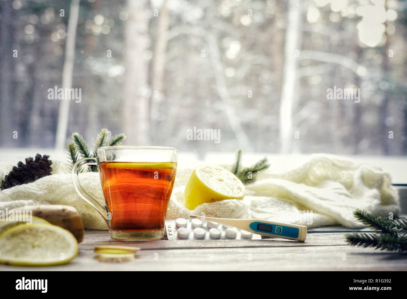 Top view Wooden word sick, Tea with lemon, thermometer, ginger, honey ...