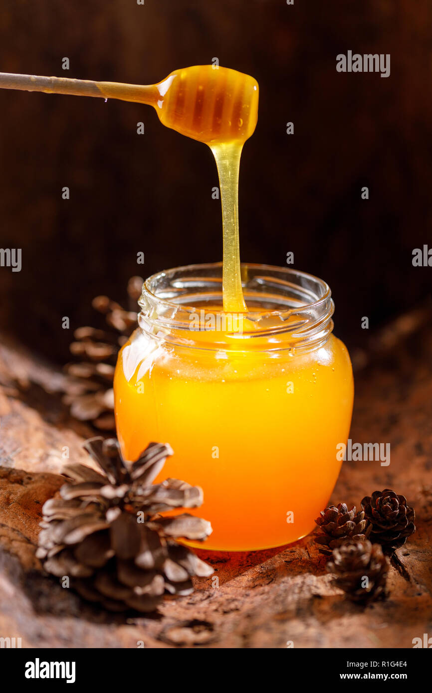 Honey falling from wooden dipper hi-res stock photography and images ...