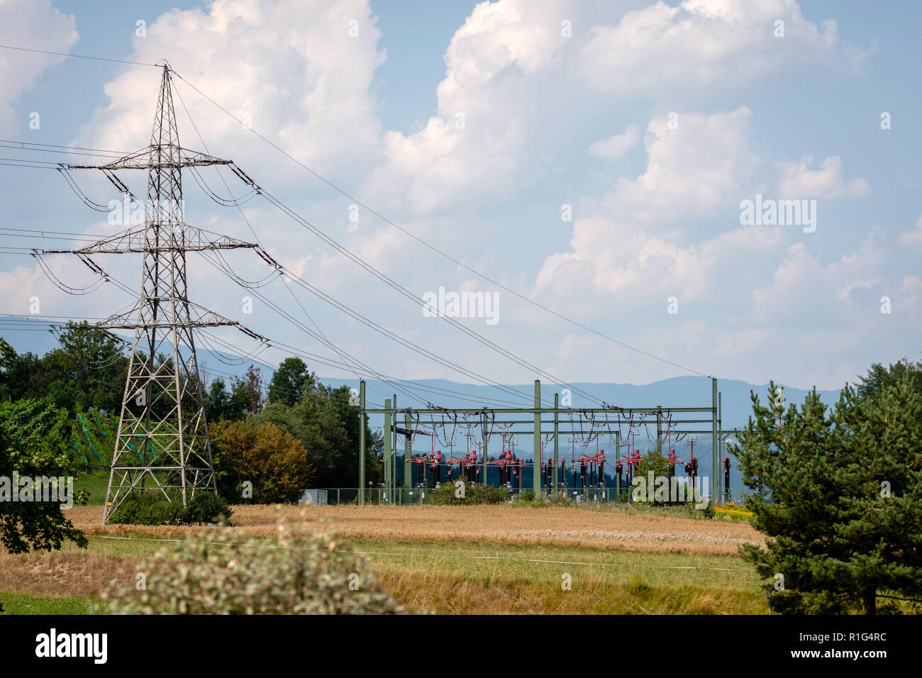 High-voltage substation on mountains and blue sky background Stock ...