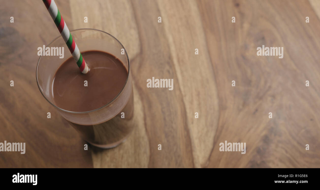 Cocoa with christmas striped paper straw on wood background with copy ...