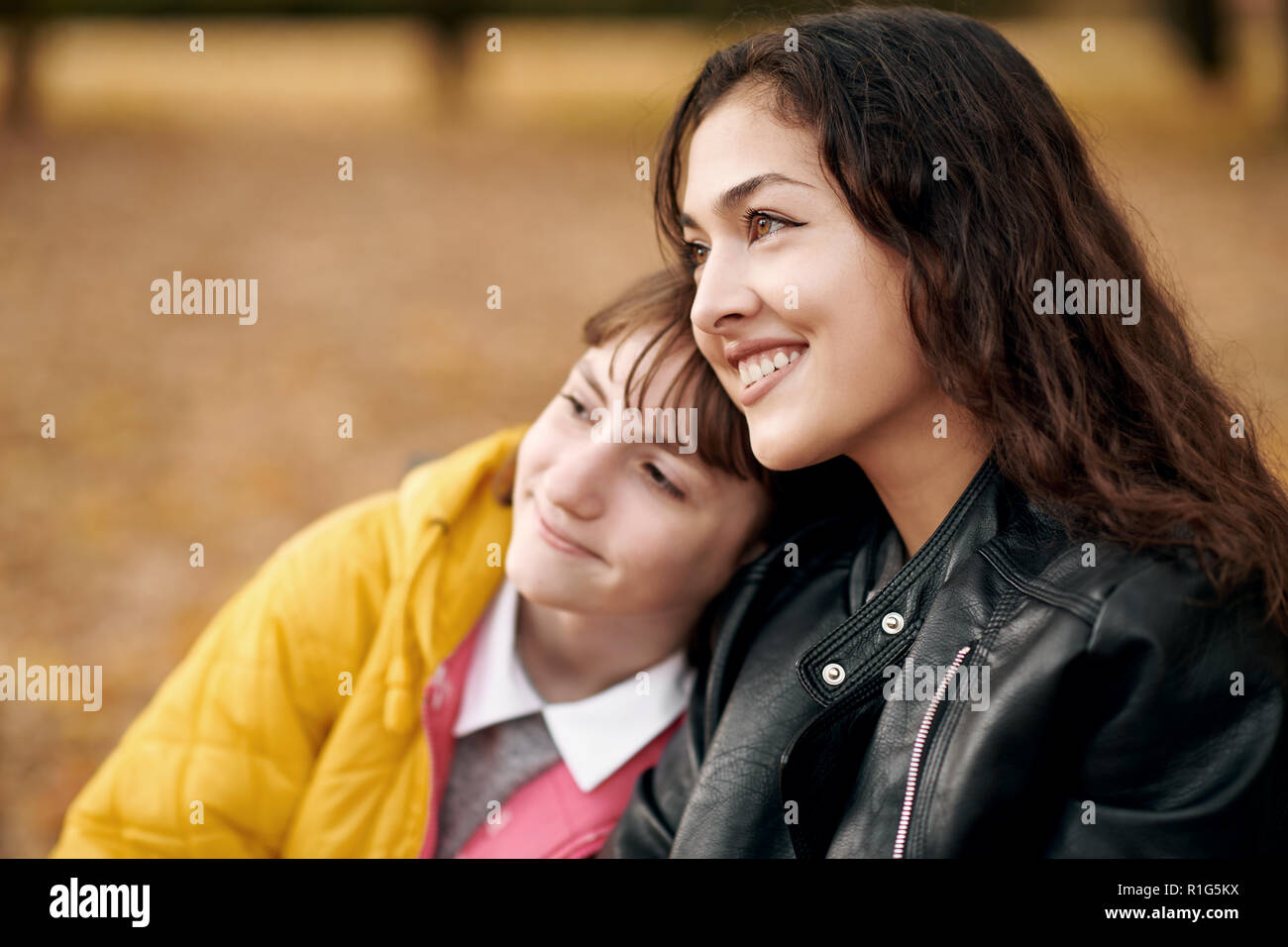 Two girls sister posing in city park hi-res stock photography and ...
