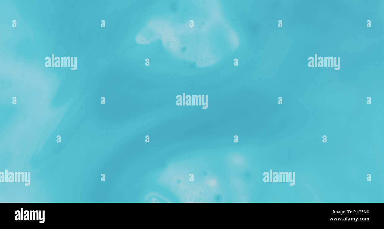 blue ink drops spreads on white plastic background, wide photo Stock ...