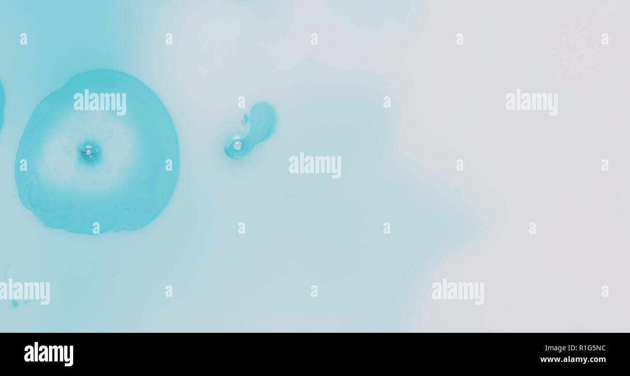 blue ink drops spreads on white plastic background, wide photo Stock ...