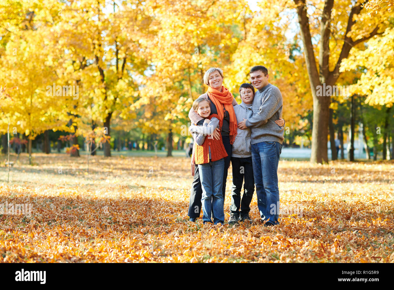 Happy family walks in autumn city park. Children and parents posing ...