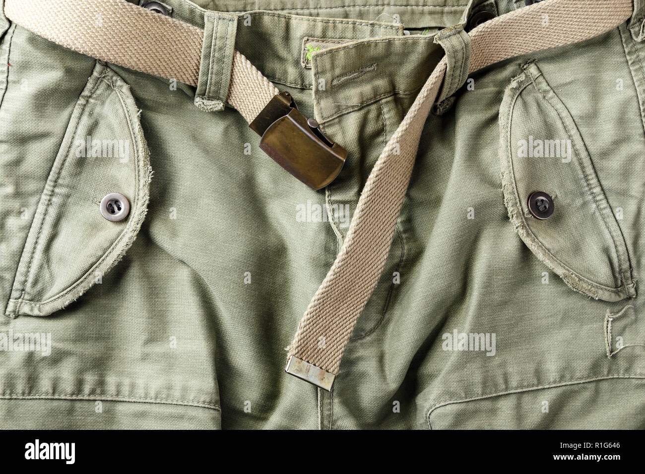 pants khaki belt. well visible fabric texture. the belt is unbuttoned ...
