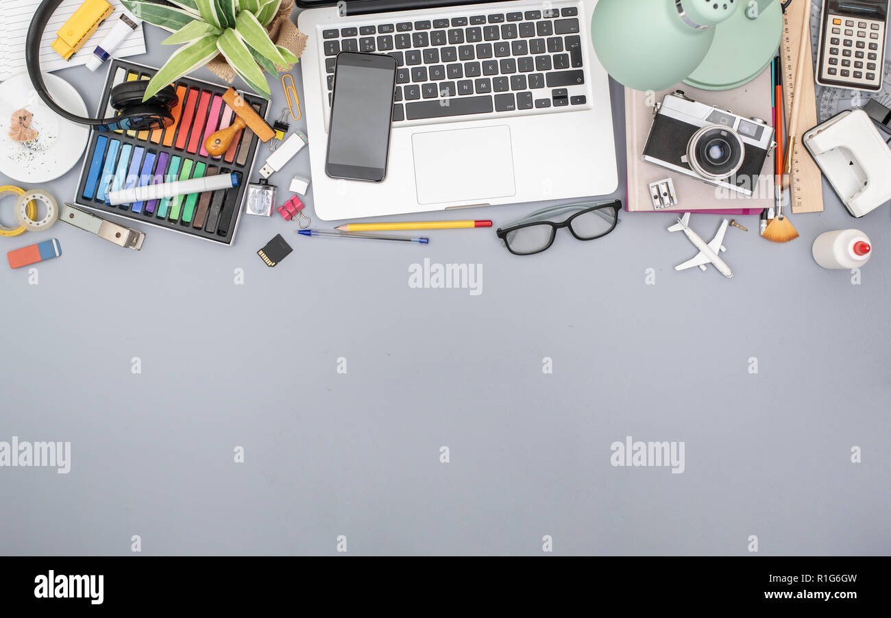top view messy creative office desk hero header Stock Photo - Alamy
