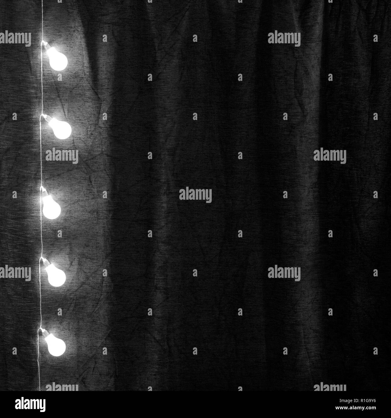 Garland of light bulbs hanging verticaly in the dark room Stock Photo ...