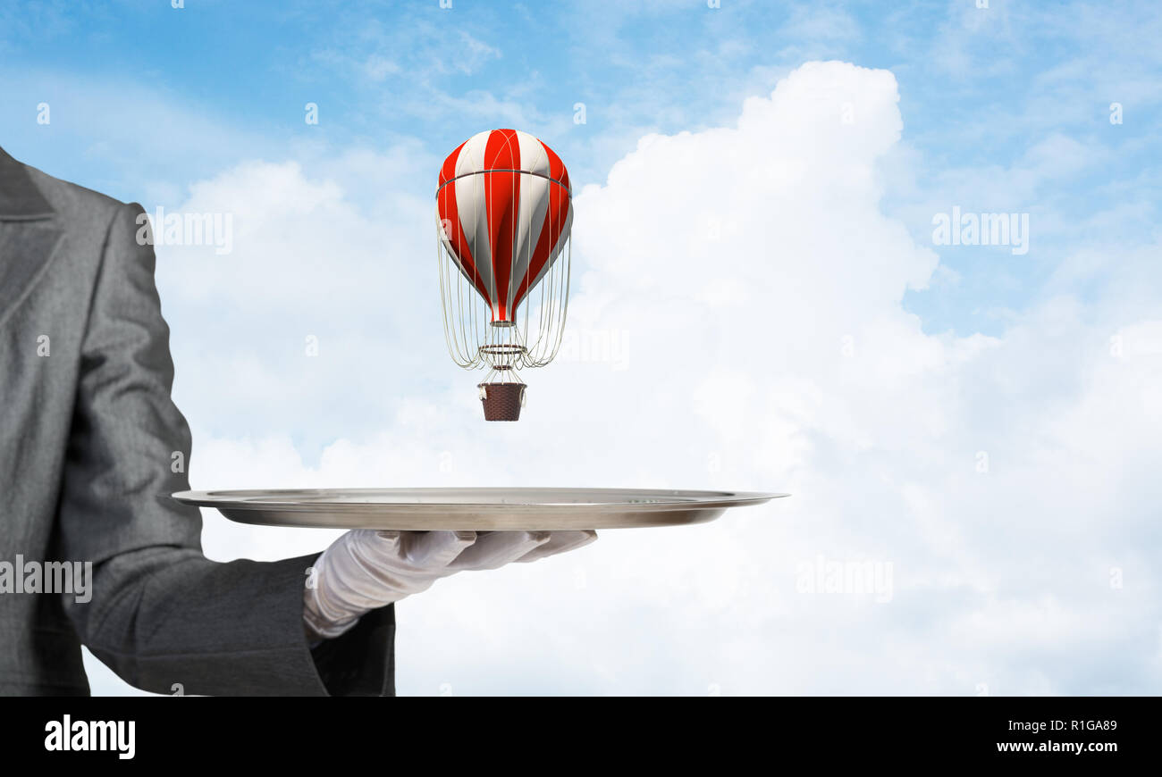 Hand of waiter presenting balloon on tray Stock Photo - Alamy