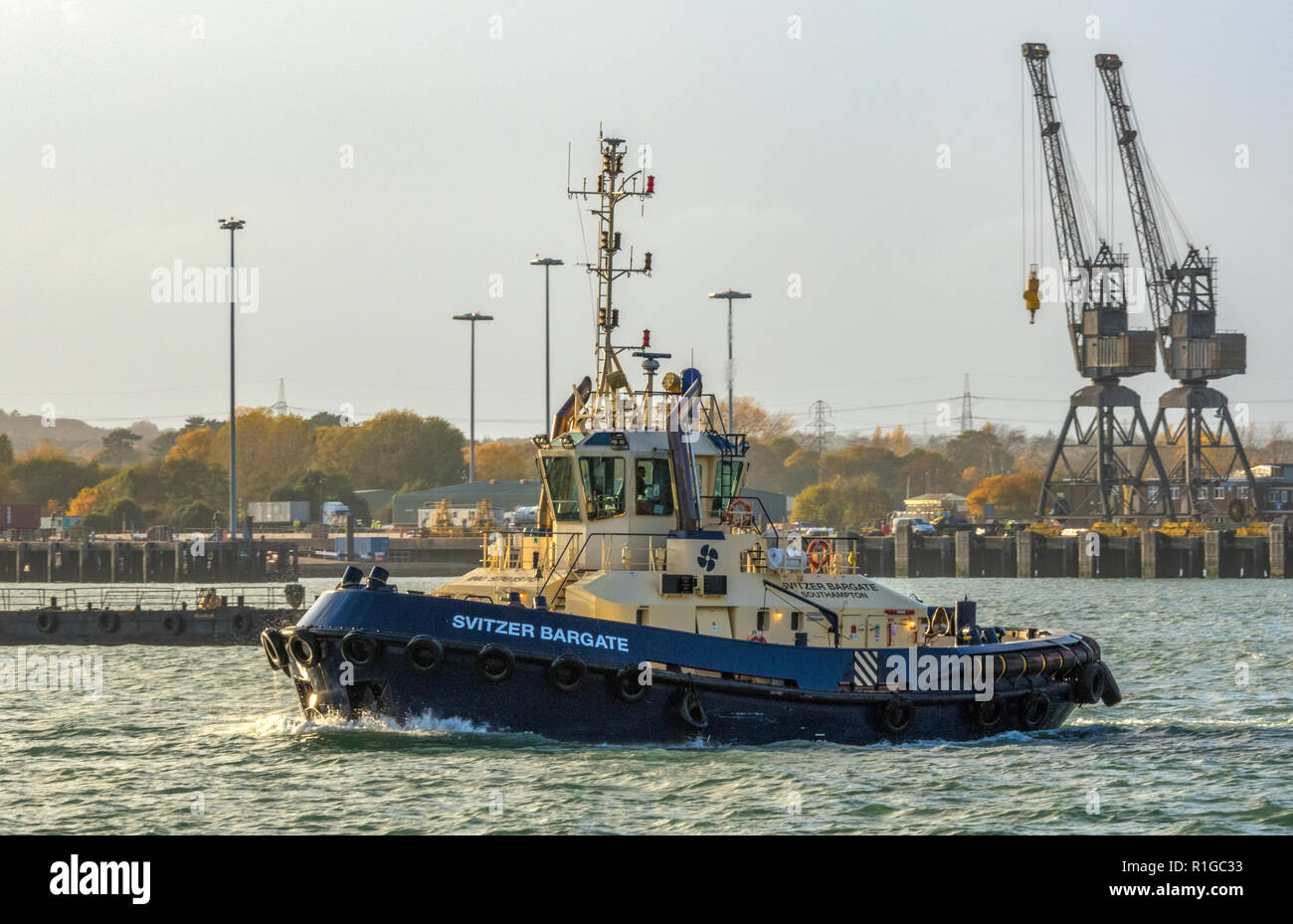 the tugboat svitzer bargate and some cranes in the port of southampton ...