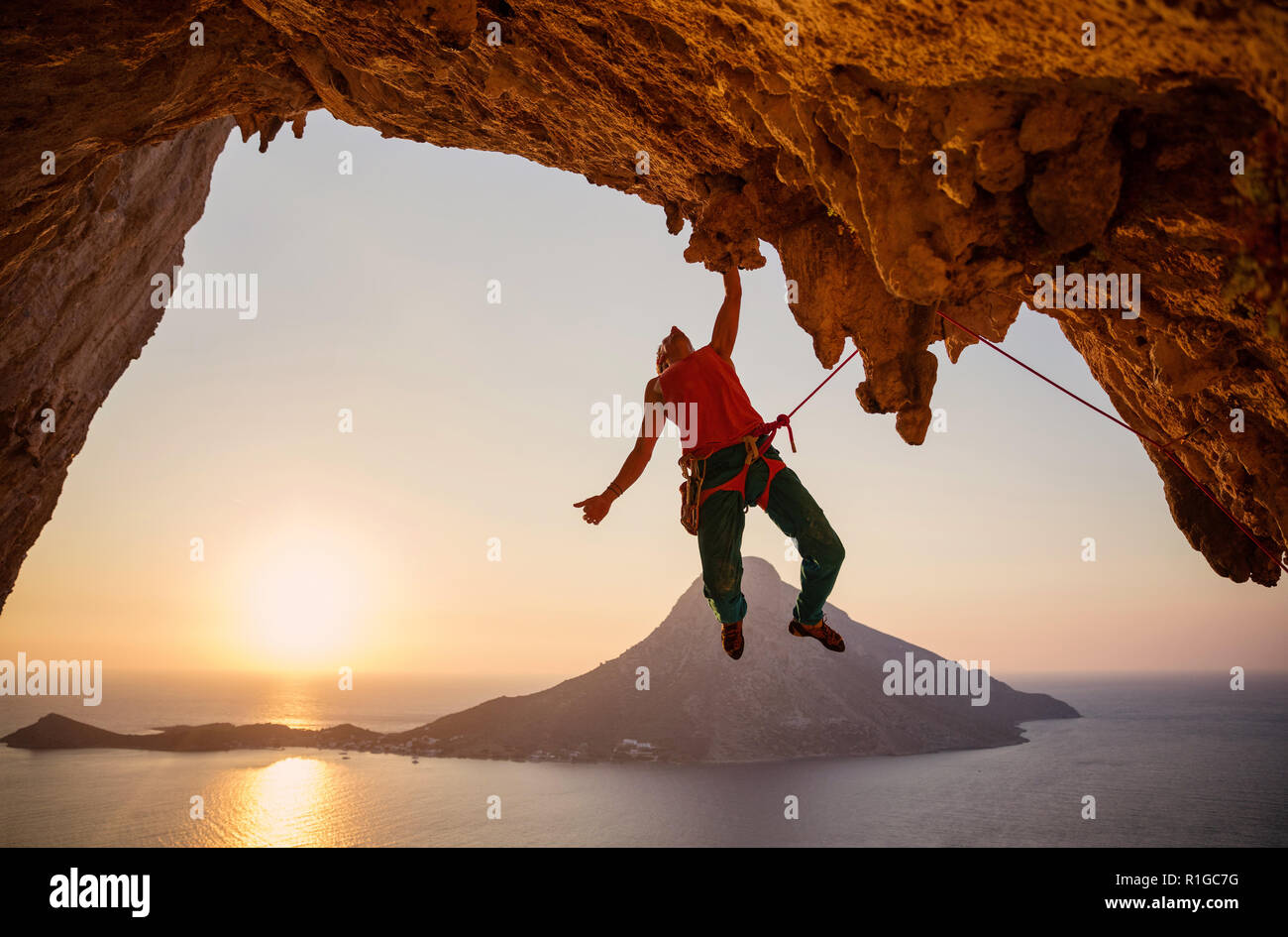 Man hanging on cliff hi-res stock photography and images - Alamy