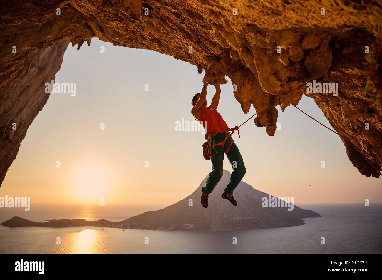 Man hanging on cliff hi-res stock photography and images - Alamy