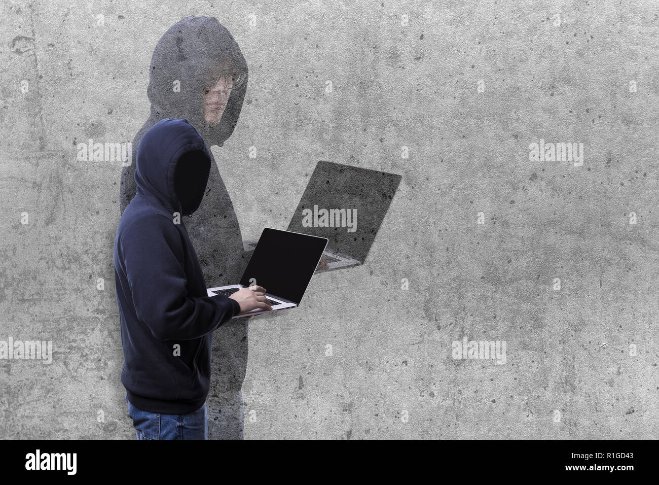 two-faced hacker hood and shadow with a face on a concrete background ...