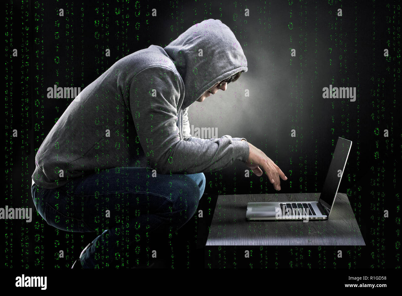 binary code on the background of a man squatting on a chair and looking ...