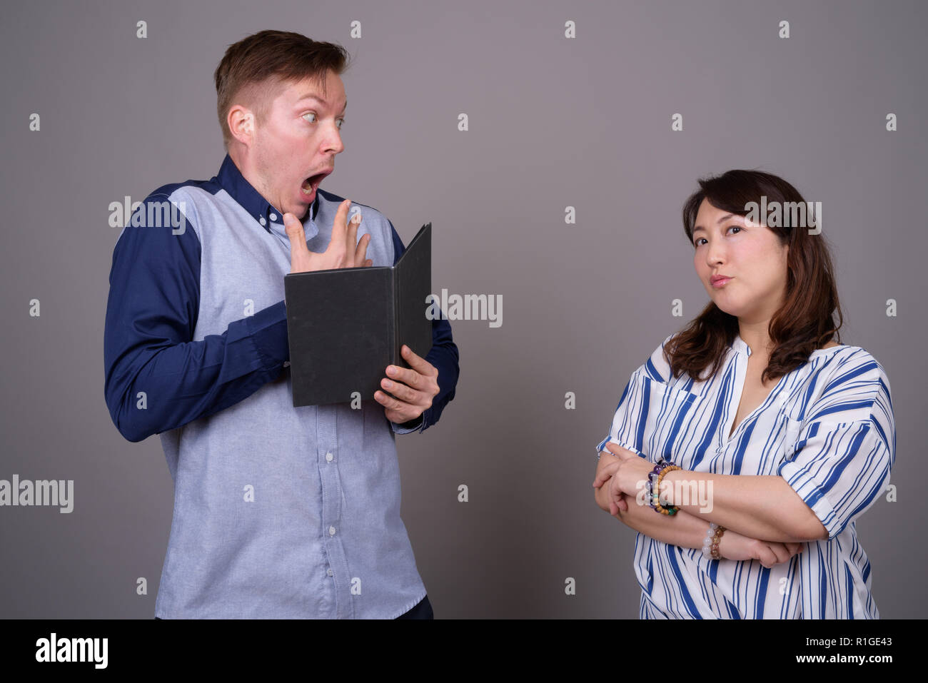 Portrait of multi ethnic diverse couple reading diary book Stock Photo ...