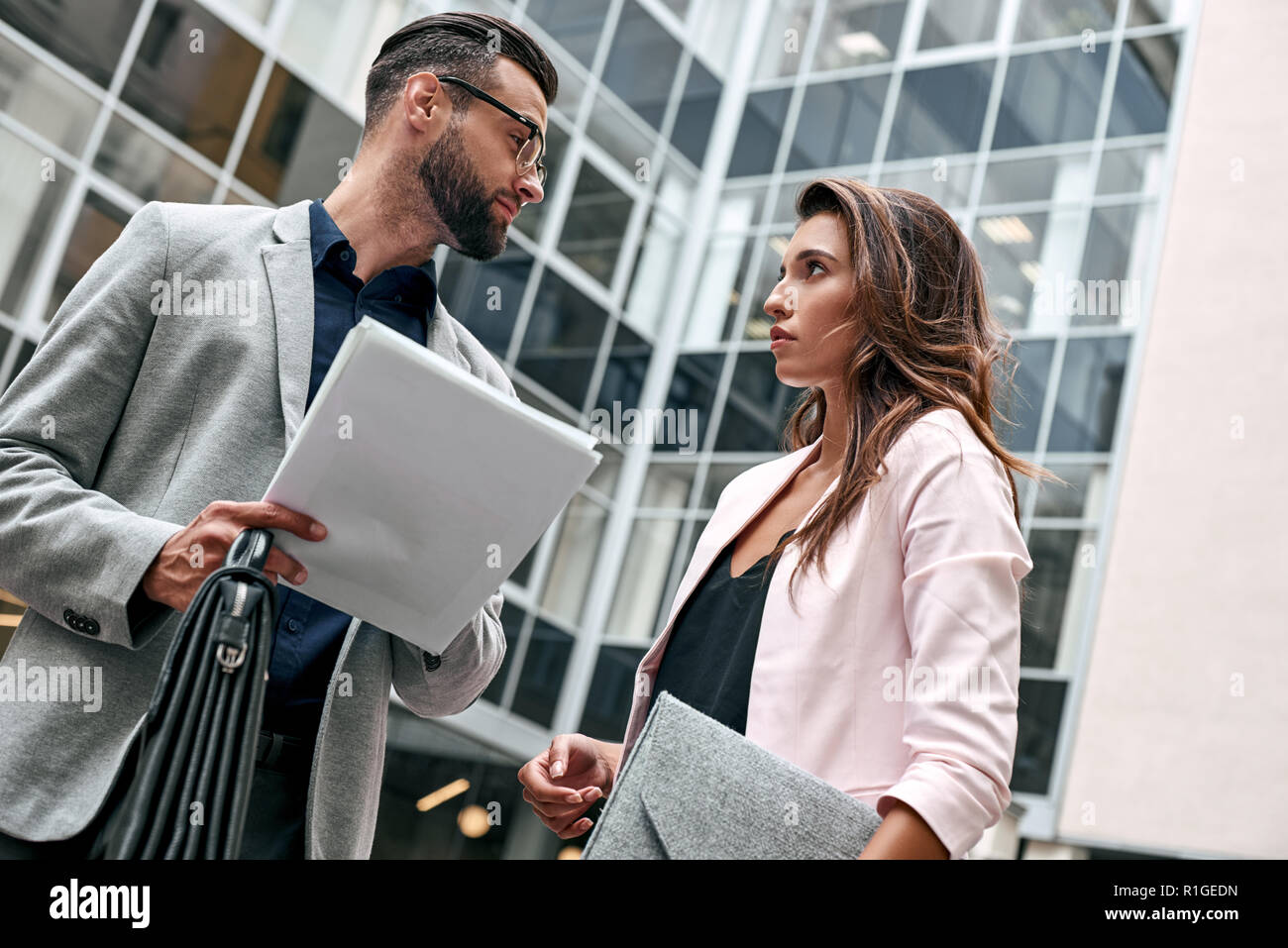 Colleagues looking documents on street hi-res stock photography and ...