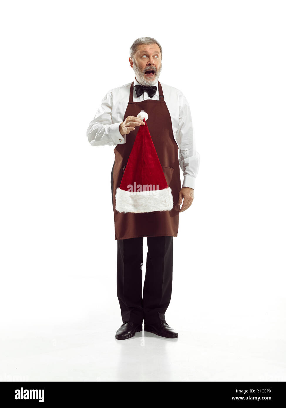 Senior waiter and standing isolated on white studio background. concept ...