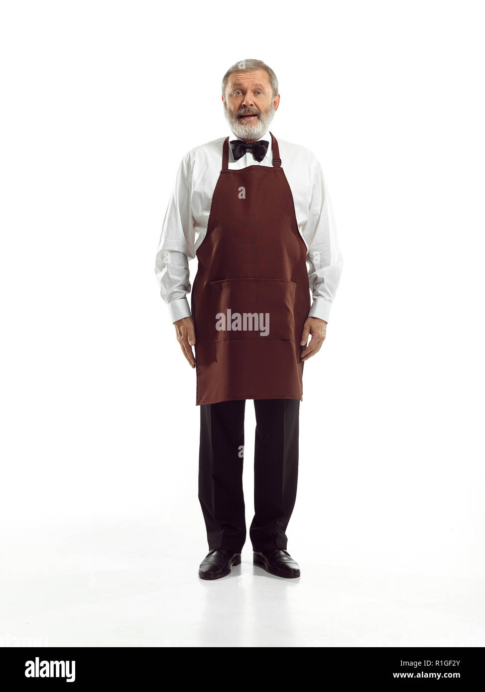 Senior waiter and standing isolated on white studio background. concept ...