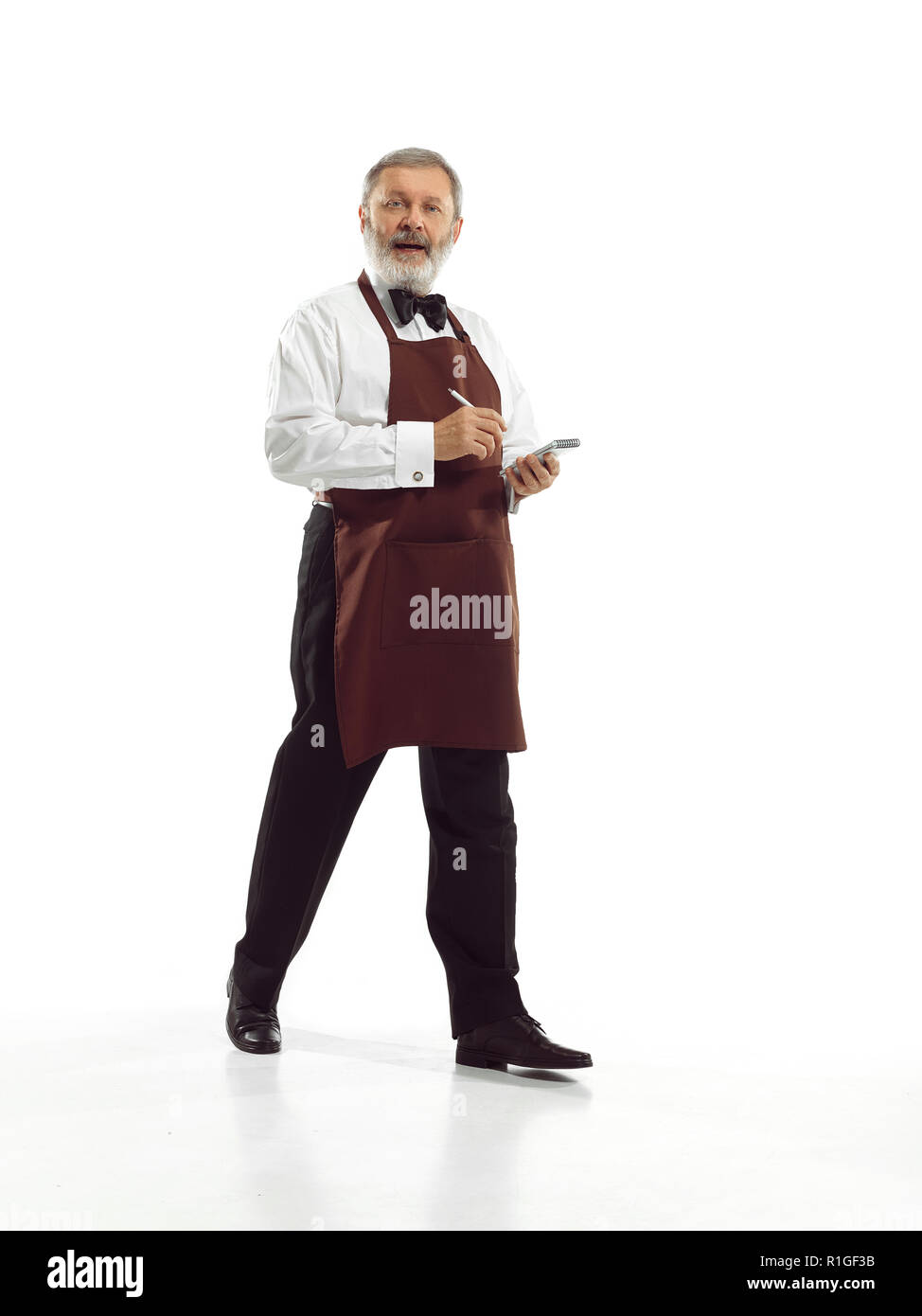 Senior waiter and standing isolated on white studio background. concept ...