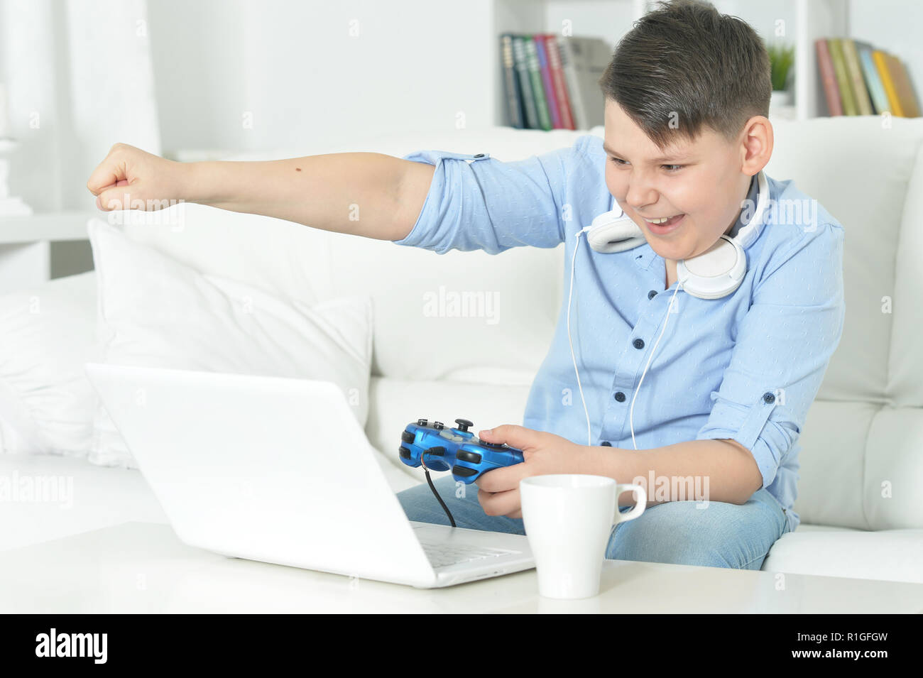 Portrait of boy playing computer game with laptop Stock Photo - Alamy