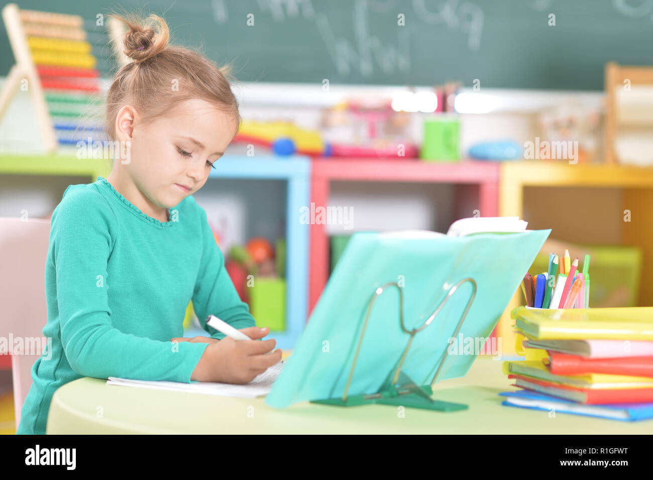 Portrait of a cute schoolgirl doing homework Stock Photo - Alamy