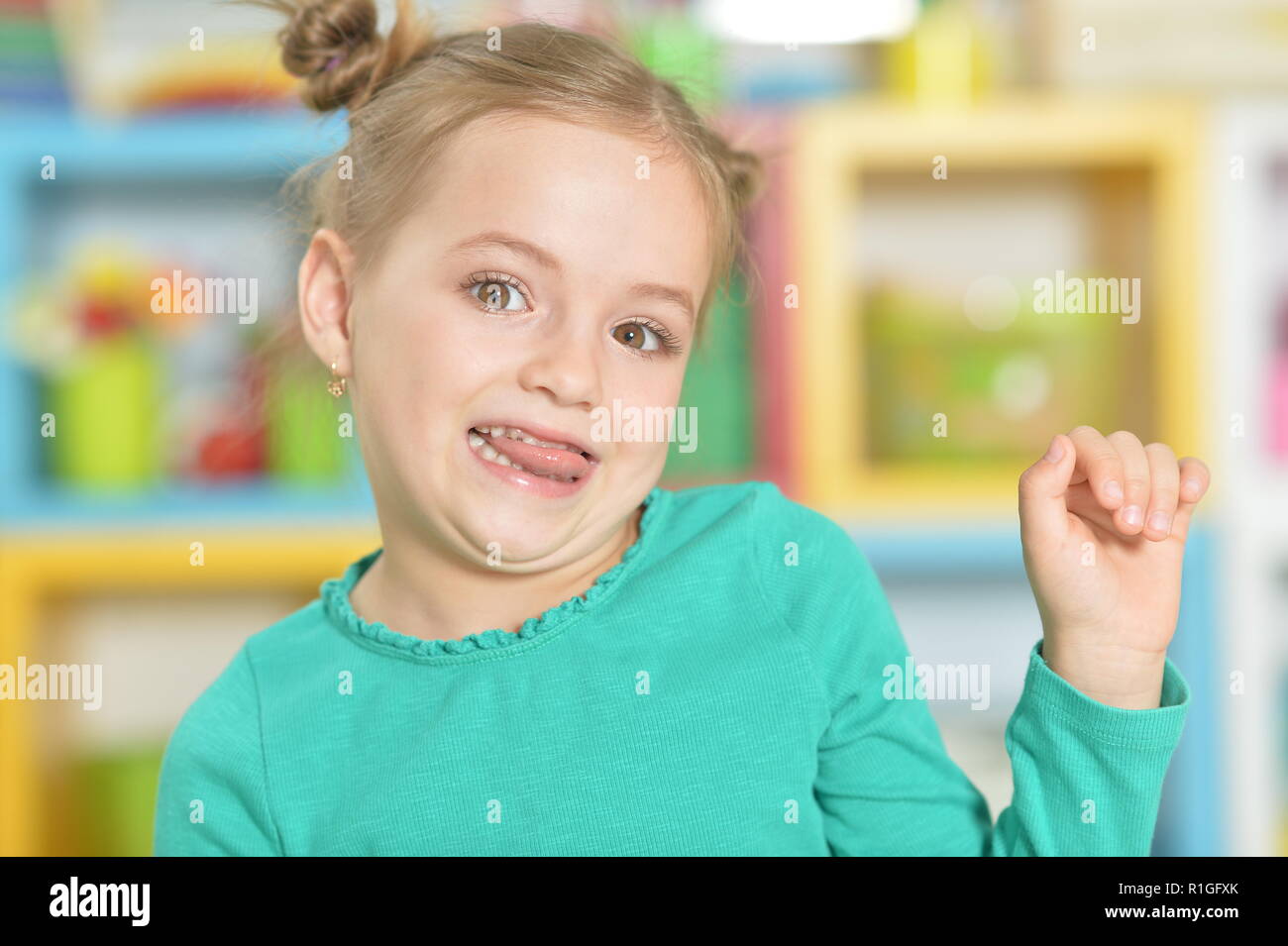Portrait of little girl making funny faces Stock Photo - Alamy