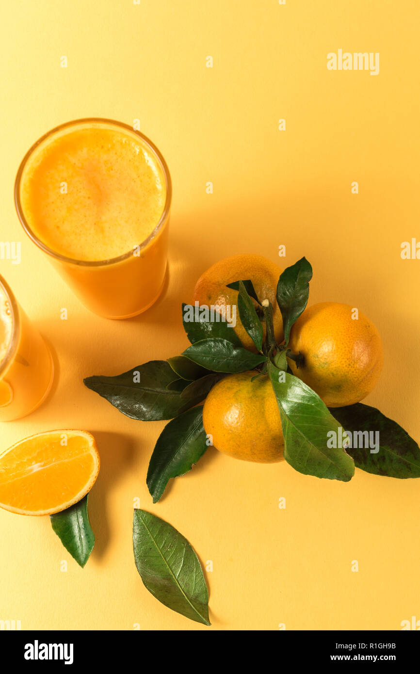 Flat lay view of Orange juice in a glass and ripe mandarin fruit with ...