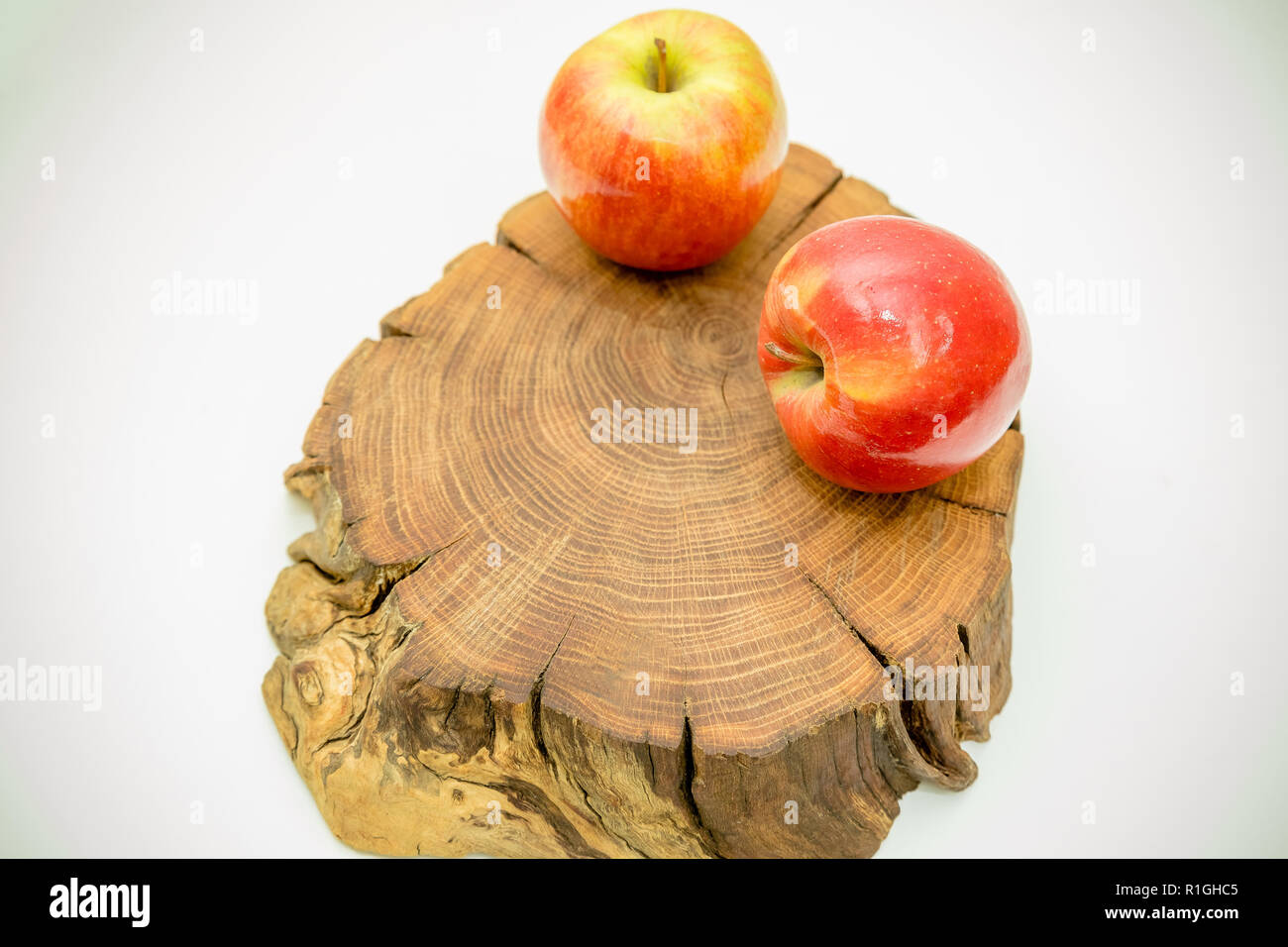 red Apples on a tree stump isolated on white background.piece of wood ...