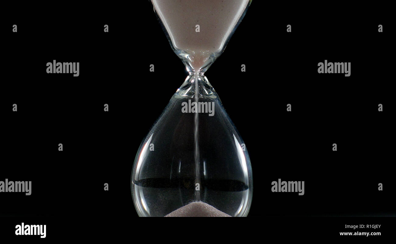 Photo of a isolated hourglass: an ancient clock, an instrument for ...