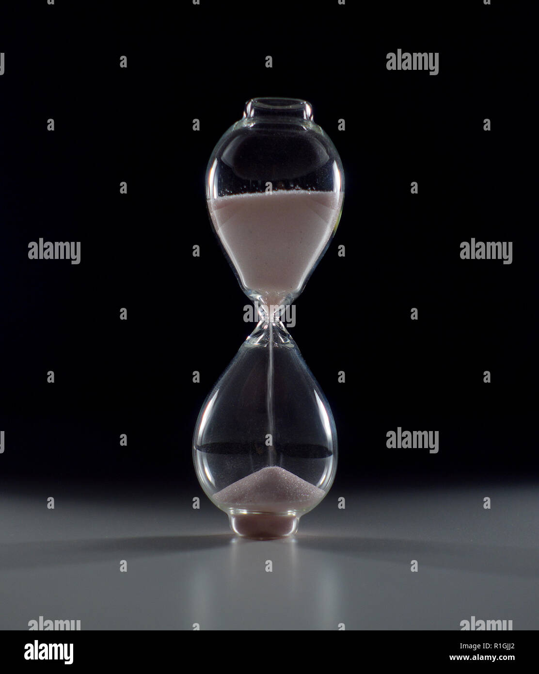 Photo of a isolated hourglass: an ancient clock, an instrument for ...