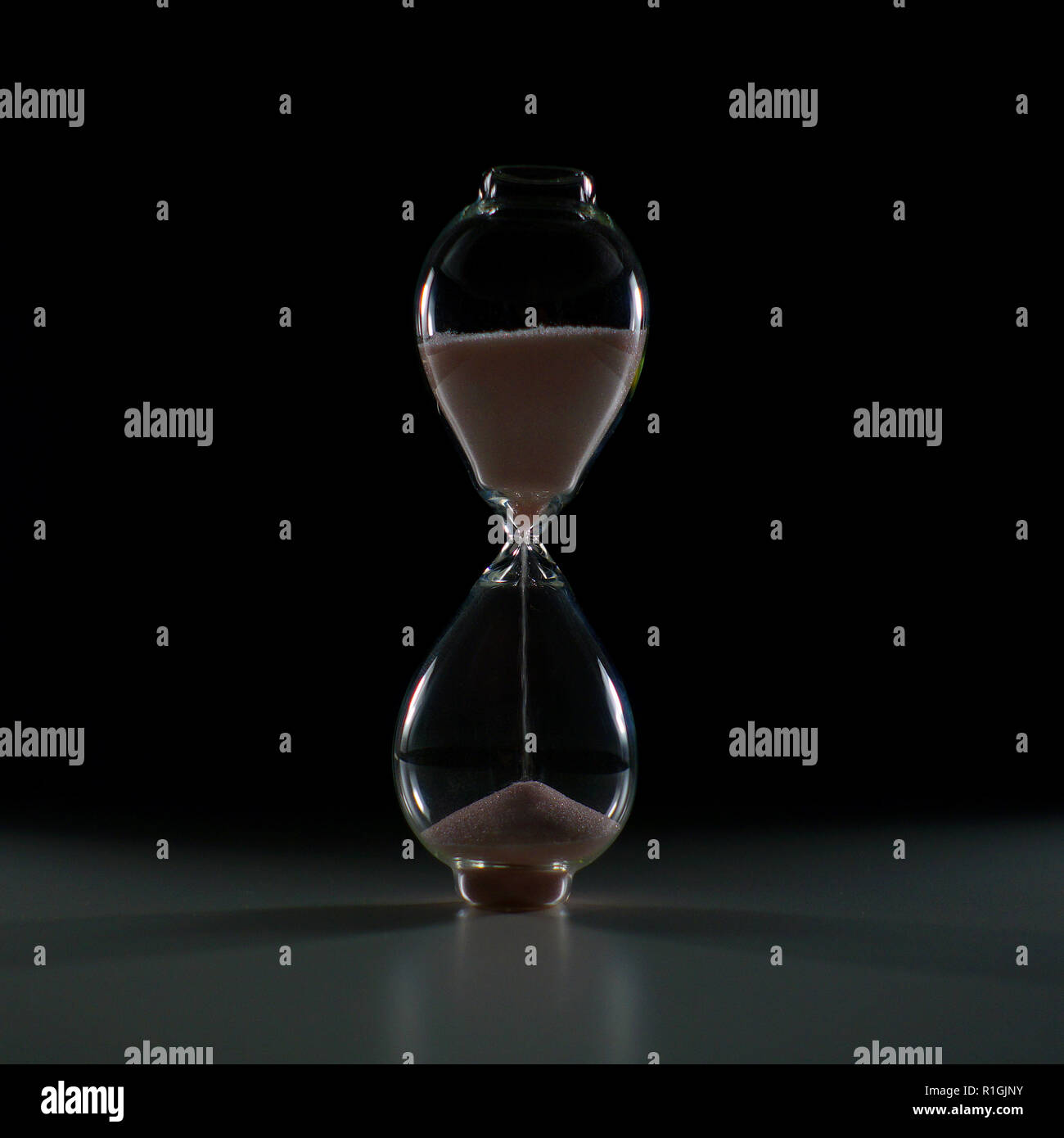 Photo of a isolated hourglass: an ancient clock, an instrument for ...