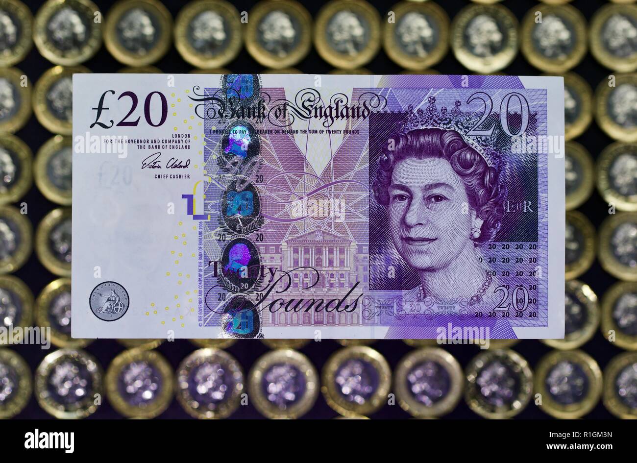 Bank of England £20 banknote with the new £1 coins in the background ...