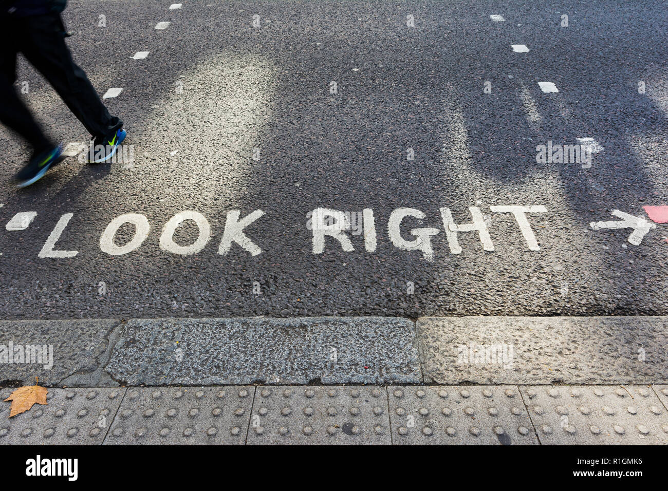"Look Right", sign on road edge advising safety for pedestrians. London ...