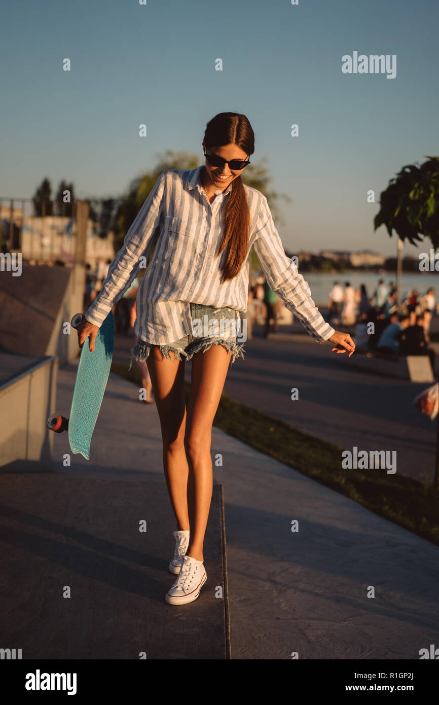Beautiful, young girl with a skateboard in the skate park Stock Photo ...