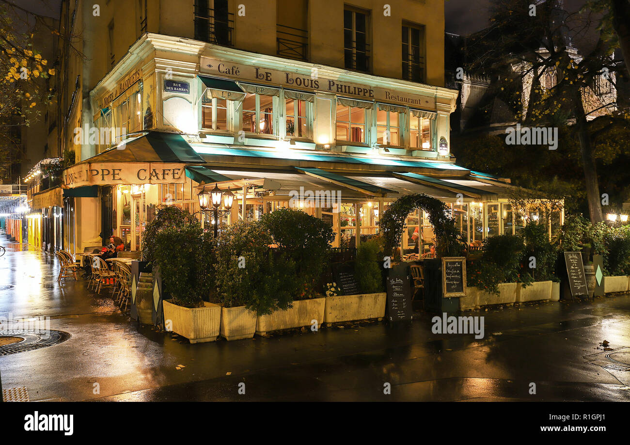 The traditional French cafe Louis Philippe at rainy night , Paris ...